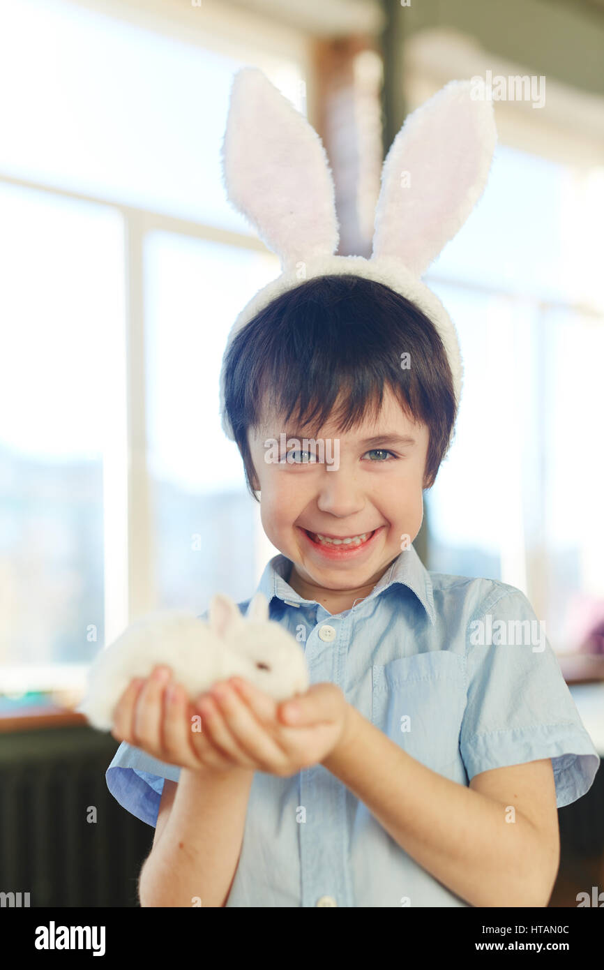 Smiling boy with white rabbit looking at camera Stock Photo - Alamy