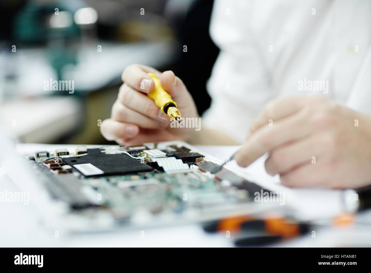 Closeup Shot Of Unrecognizable Man Assembling Circuit Board Using