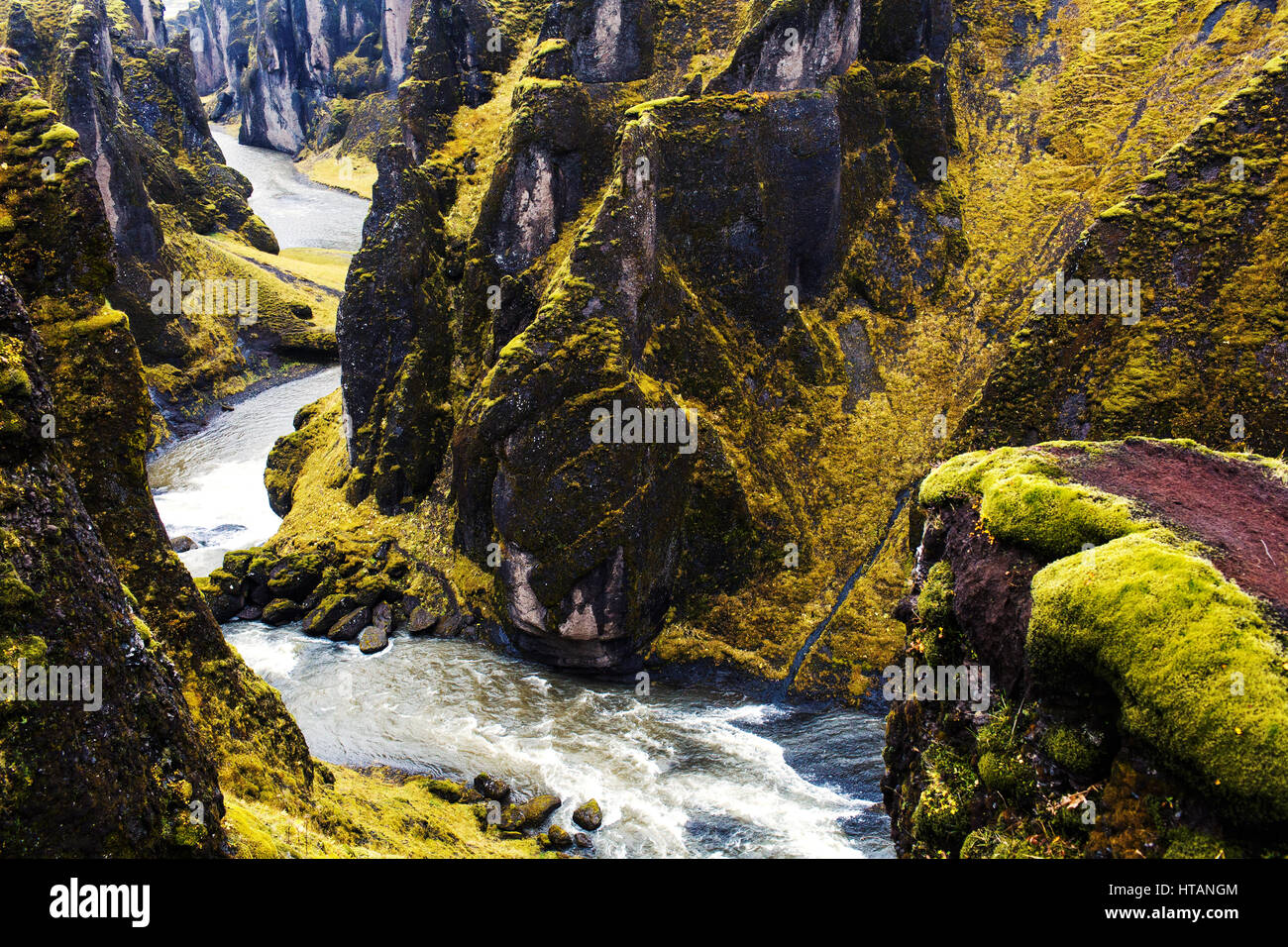 Wild flow between two rocky mountains covered by moss Stock Photo - Alamy