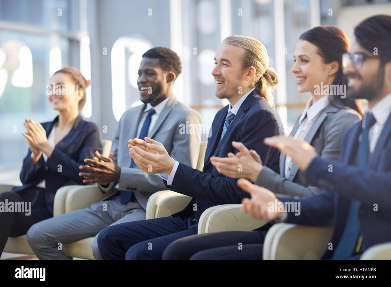Row of business people clapping hands after report of speaker Stock ...