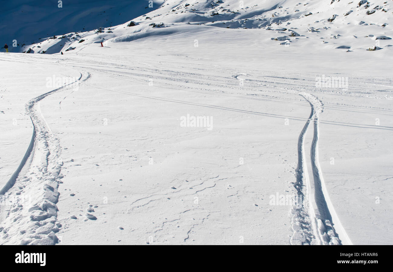Skiers on a ski slope piste in winter alpine mountain resort Stock ...