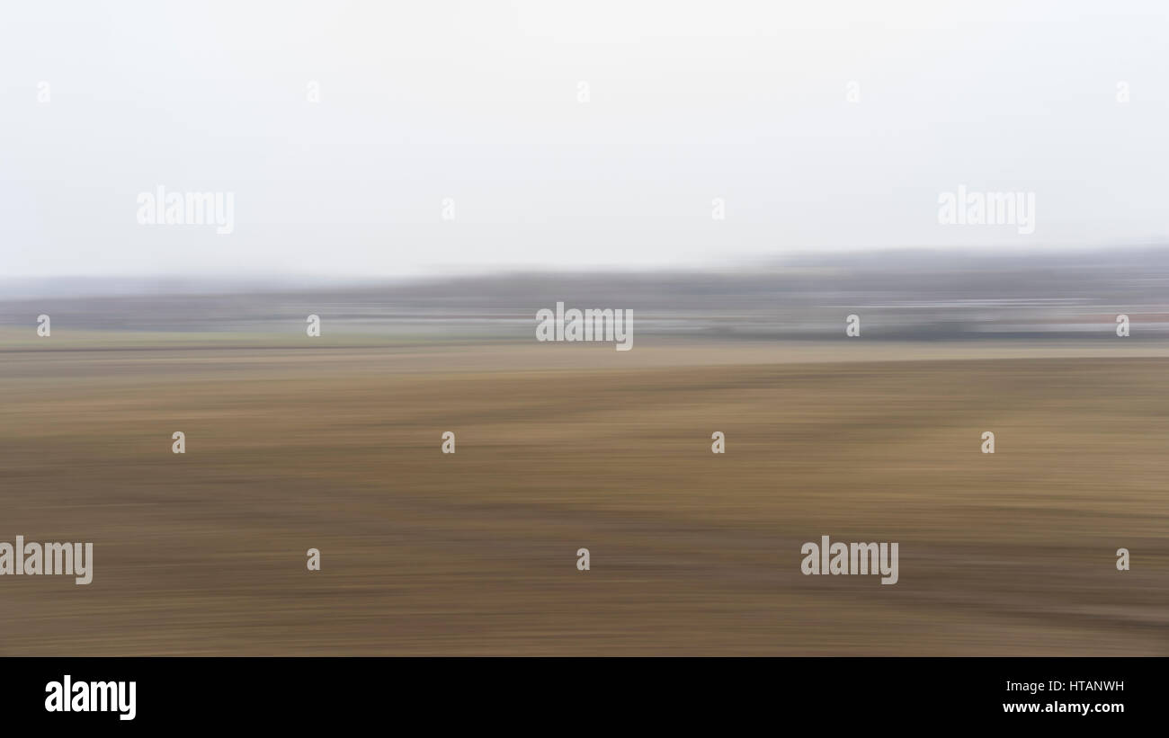 Winter view across fields blurred with horizontal camera movement Stock ...