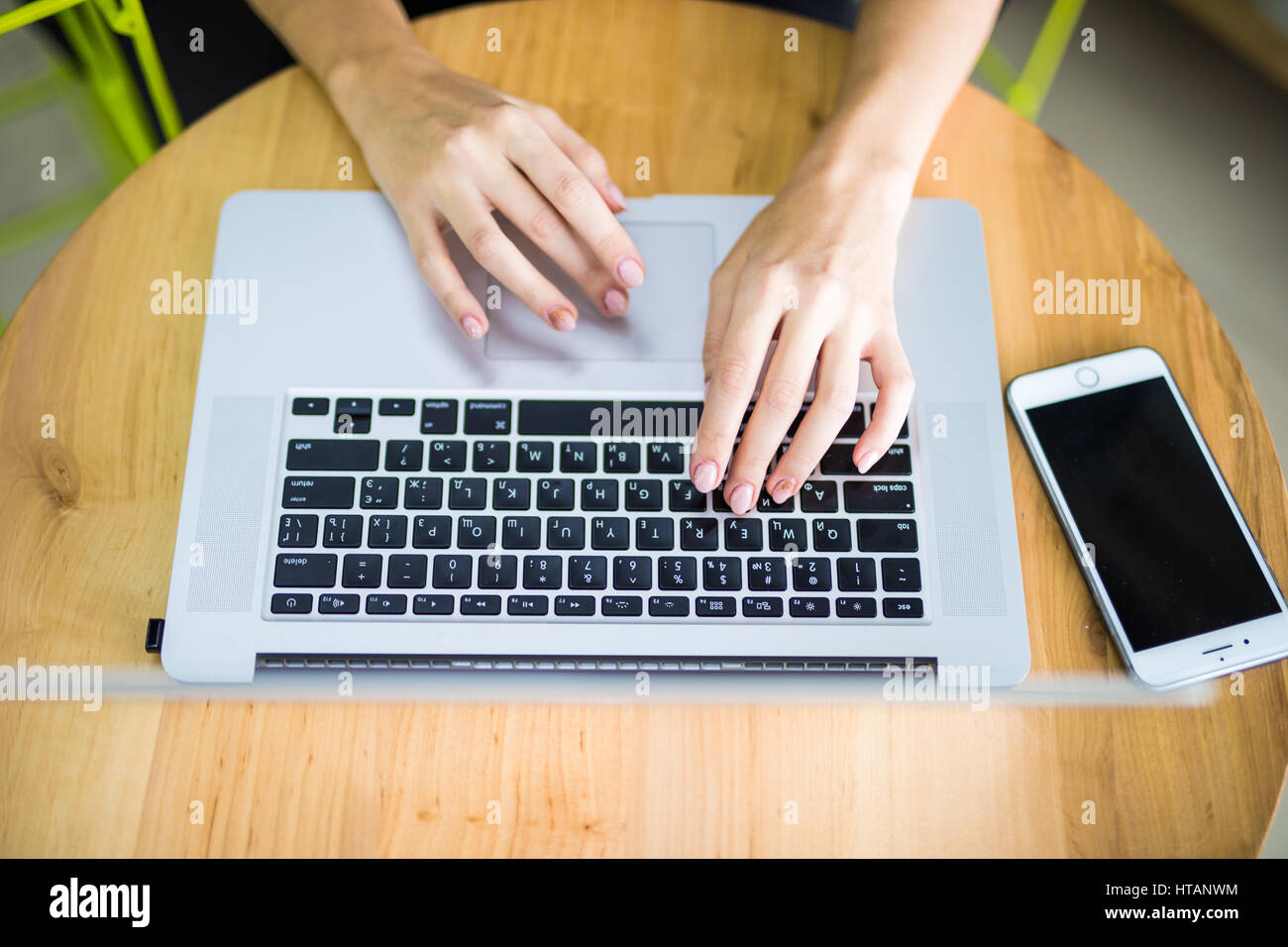 Female hands typing on computer keyboard and phone Stock Photo - Alamy