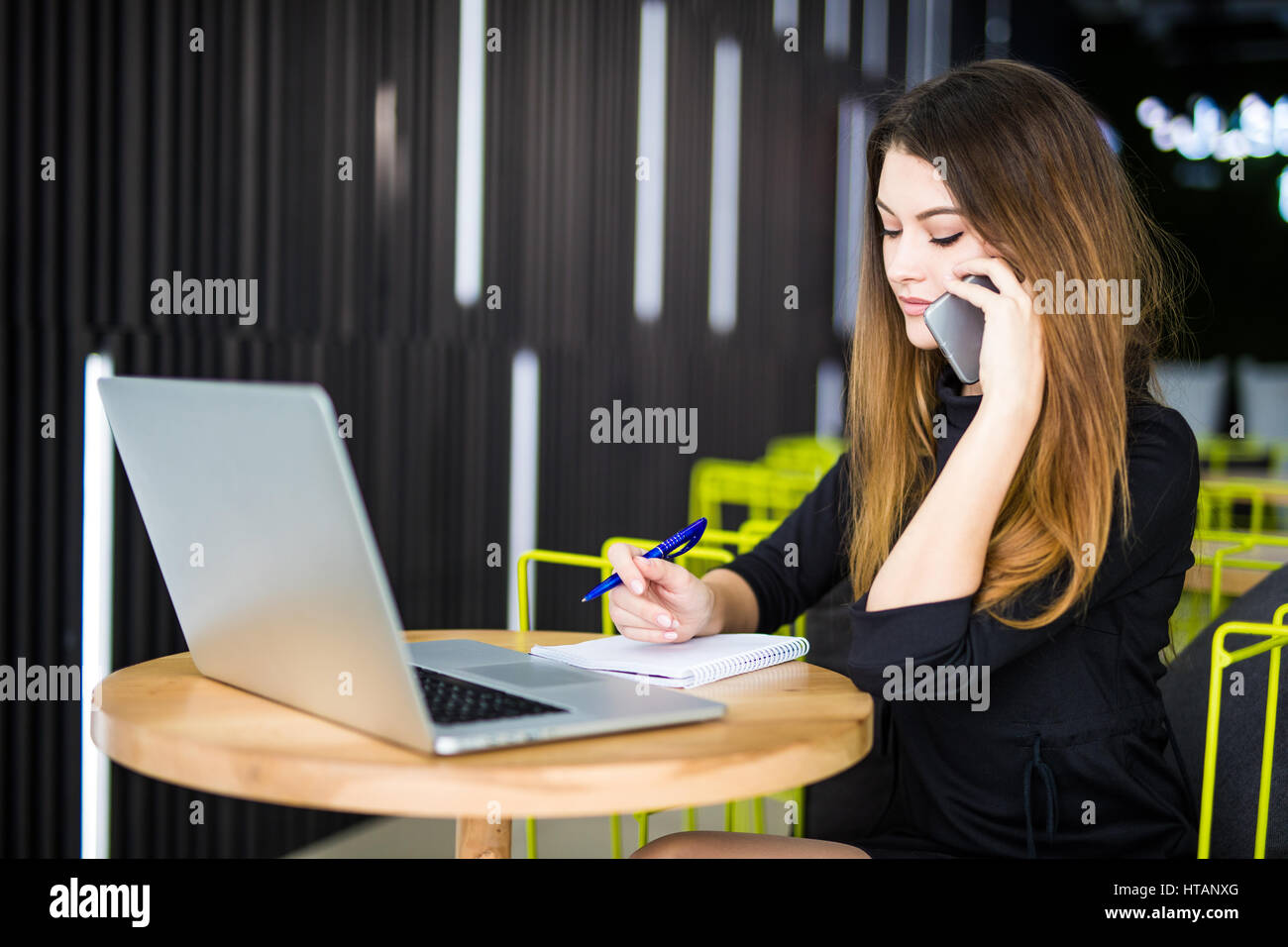 Happy pretty manager talking on mobile phone with client Stock Photo ...