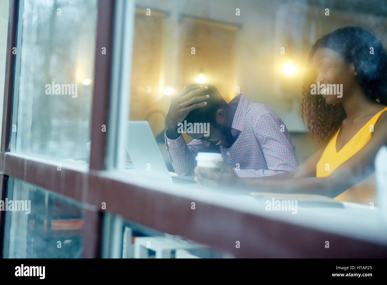 Young man laughing during conversation with his colleague Stock Photo ...