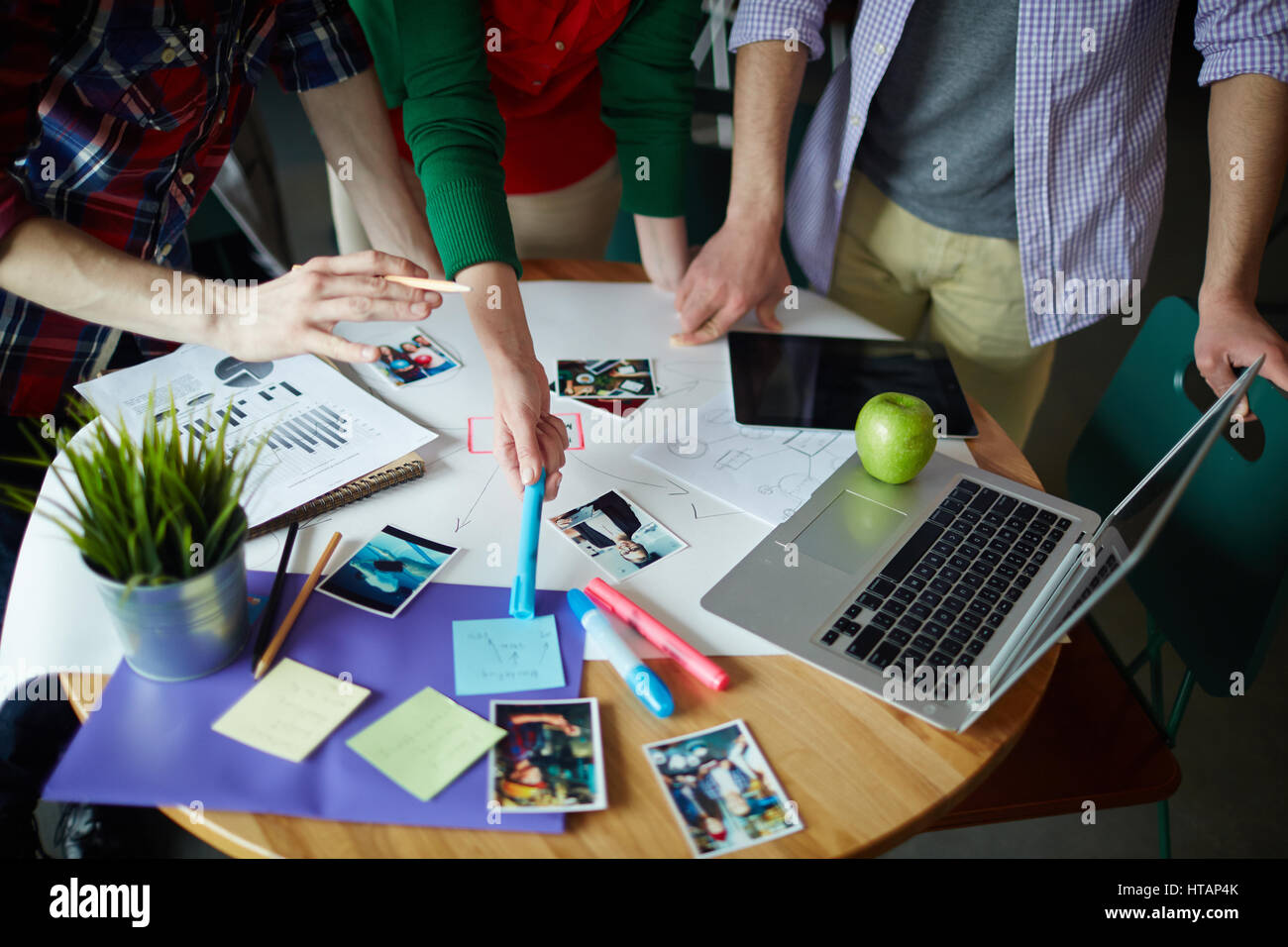 Closeup directly above shot of messy round table with office supplies ...