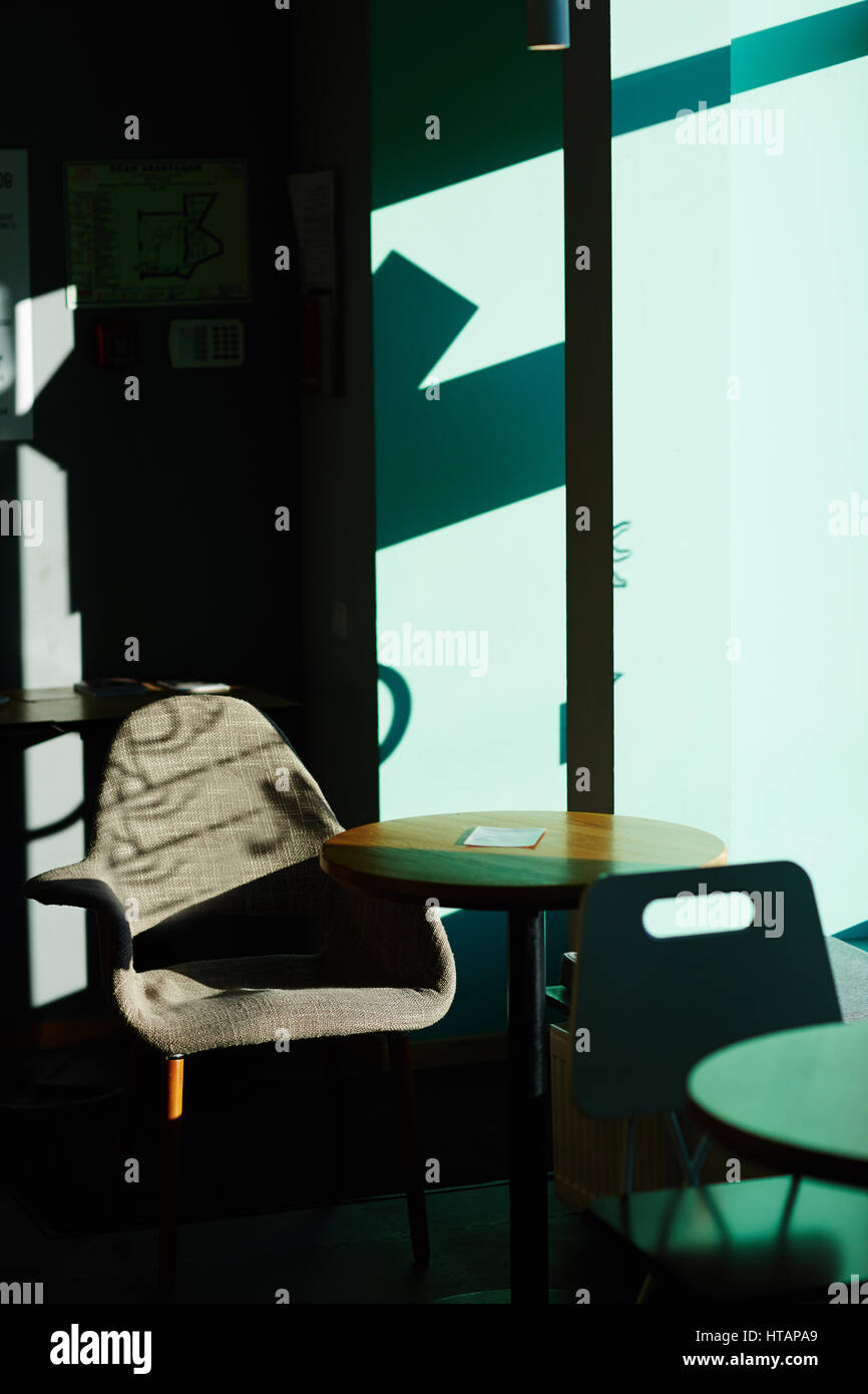 Image of empty seating area in cafe, table with chair standing by ...