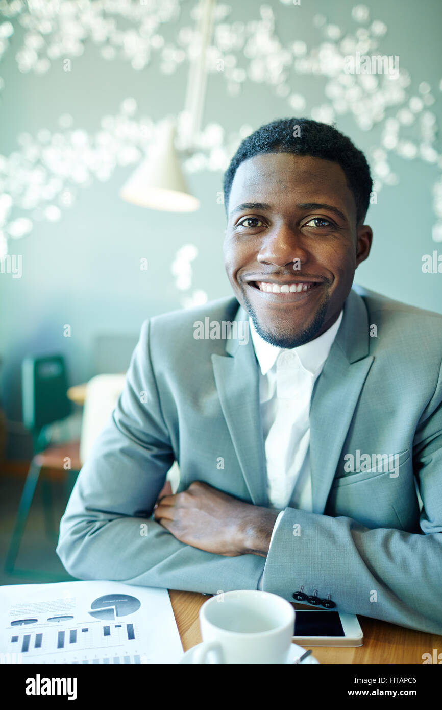 Smiling african man working papers hi-res stock photography and images ...