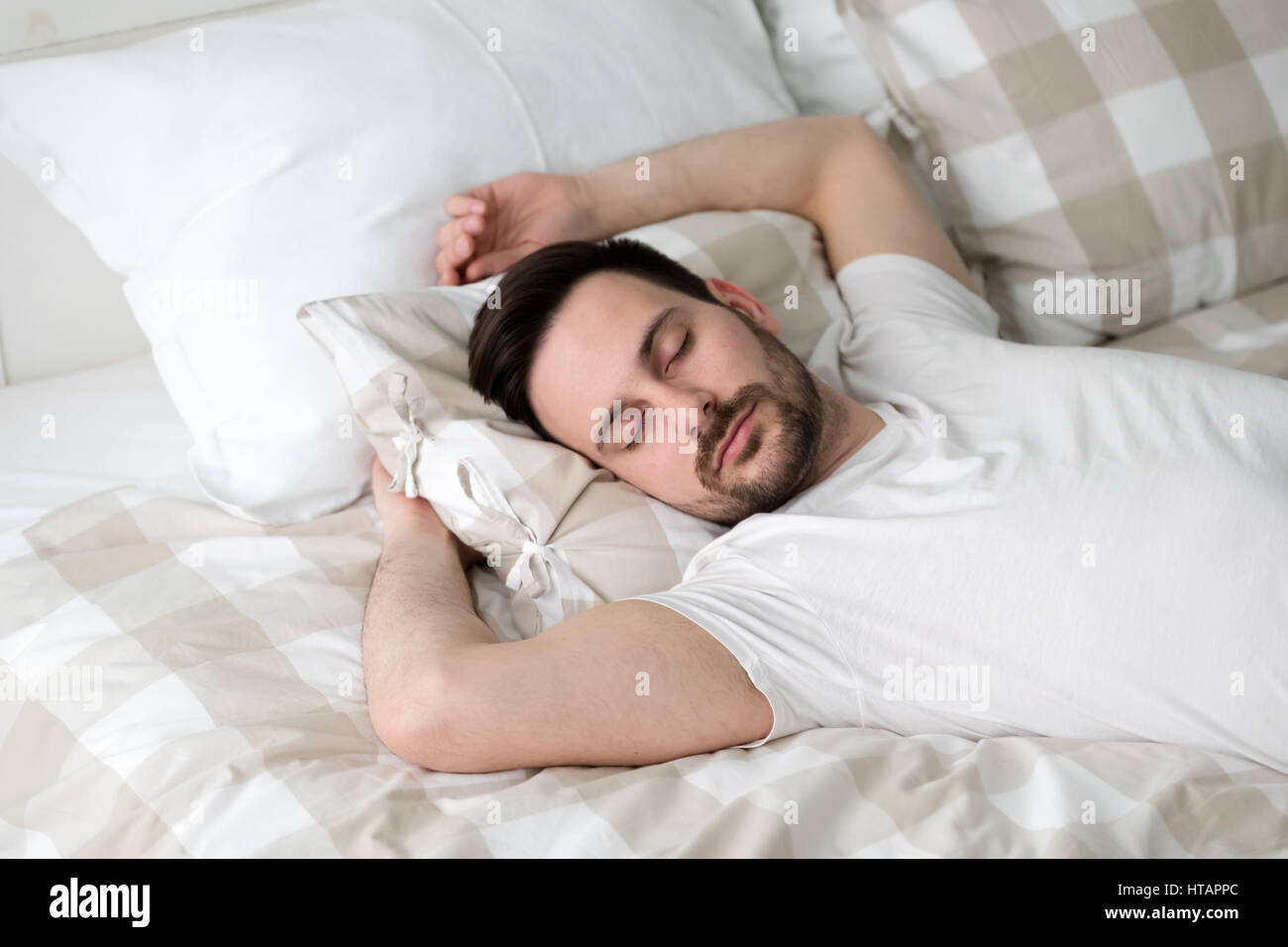 Handsome male sleeping in bed during weekend Stock Photo - Alamy