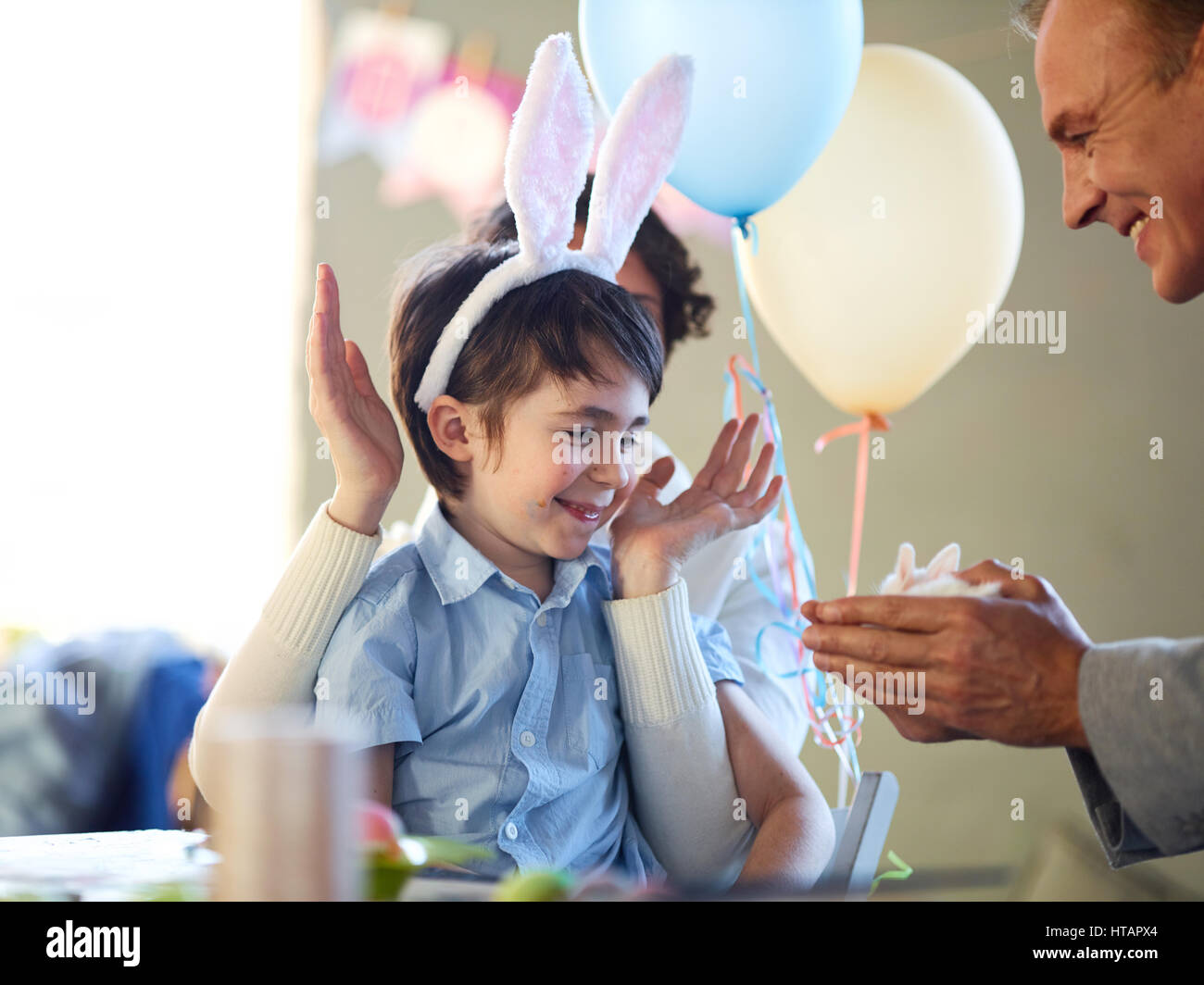 Happy boy looking at his new pet - birthday present Stock Photo - Alamy