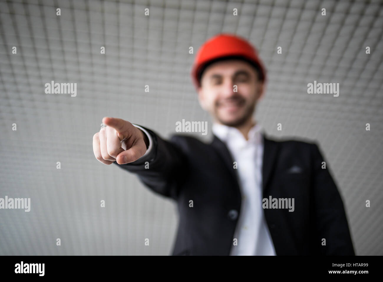 Young architect pointing at you in buildings Stock Photo - Alamy