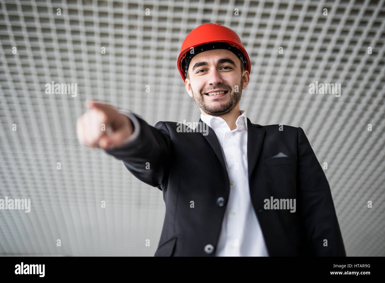 Young architect pointing at you in buildings Stock Photo - Alamy