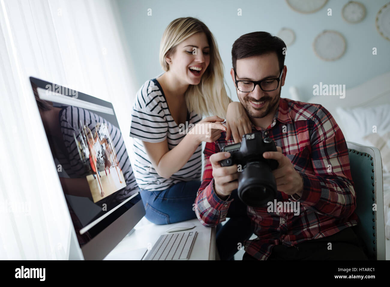 Photographer and beautiful female looking at photos on camera Stock ...