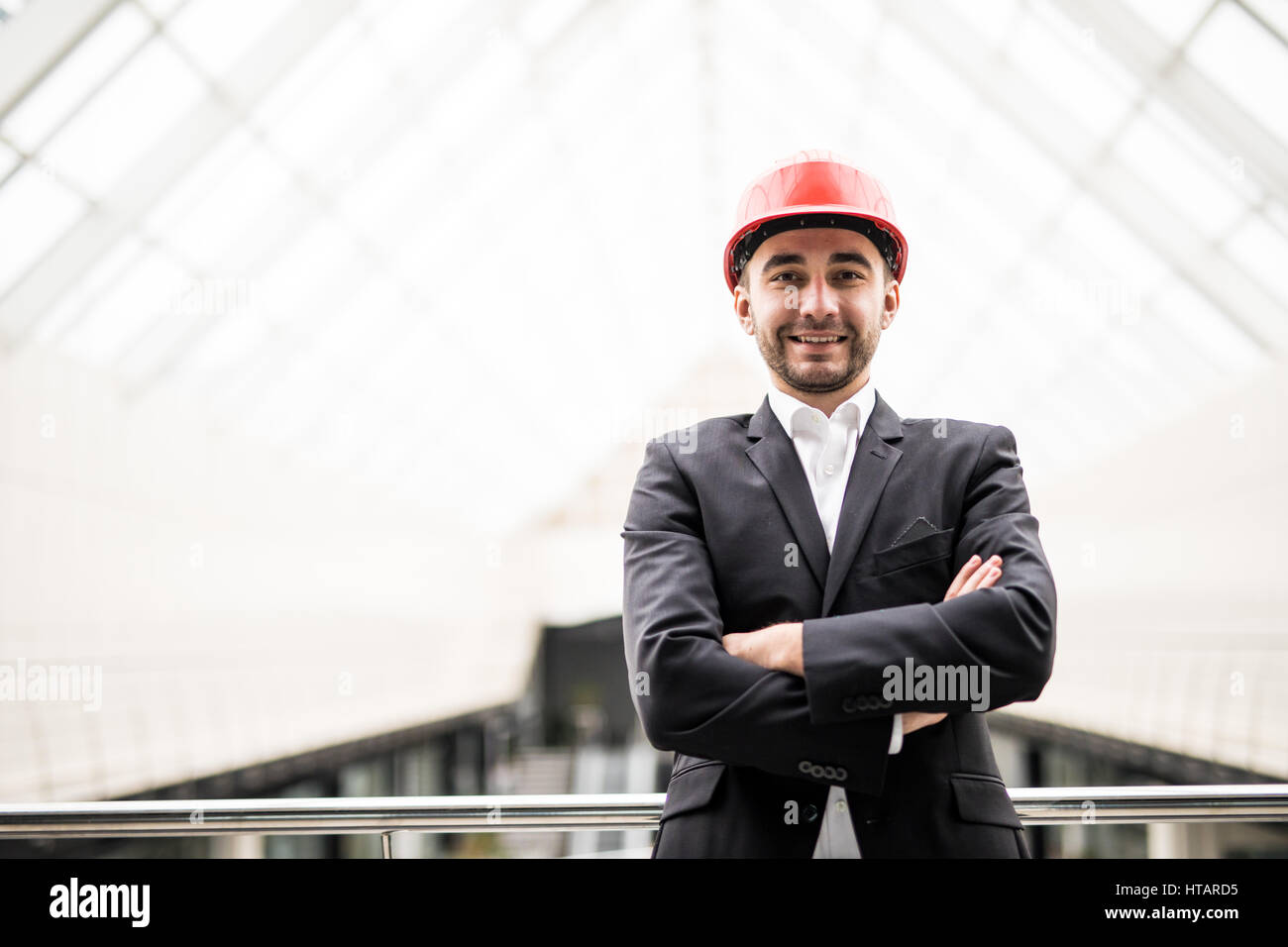 Portrait of architect designer man standing at skyscraper window ...