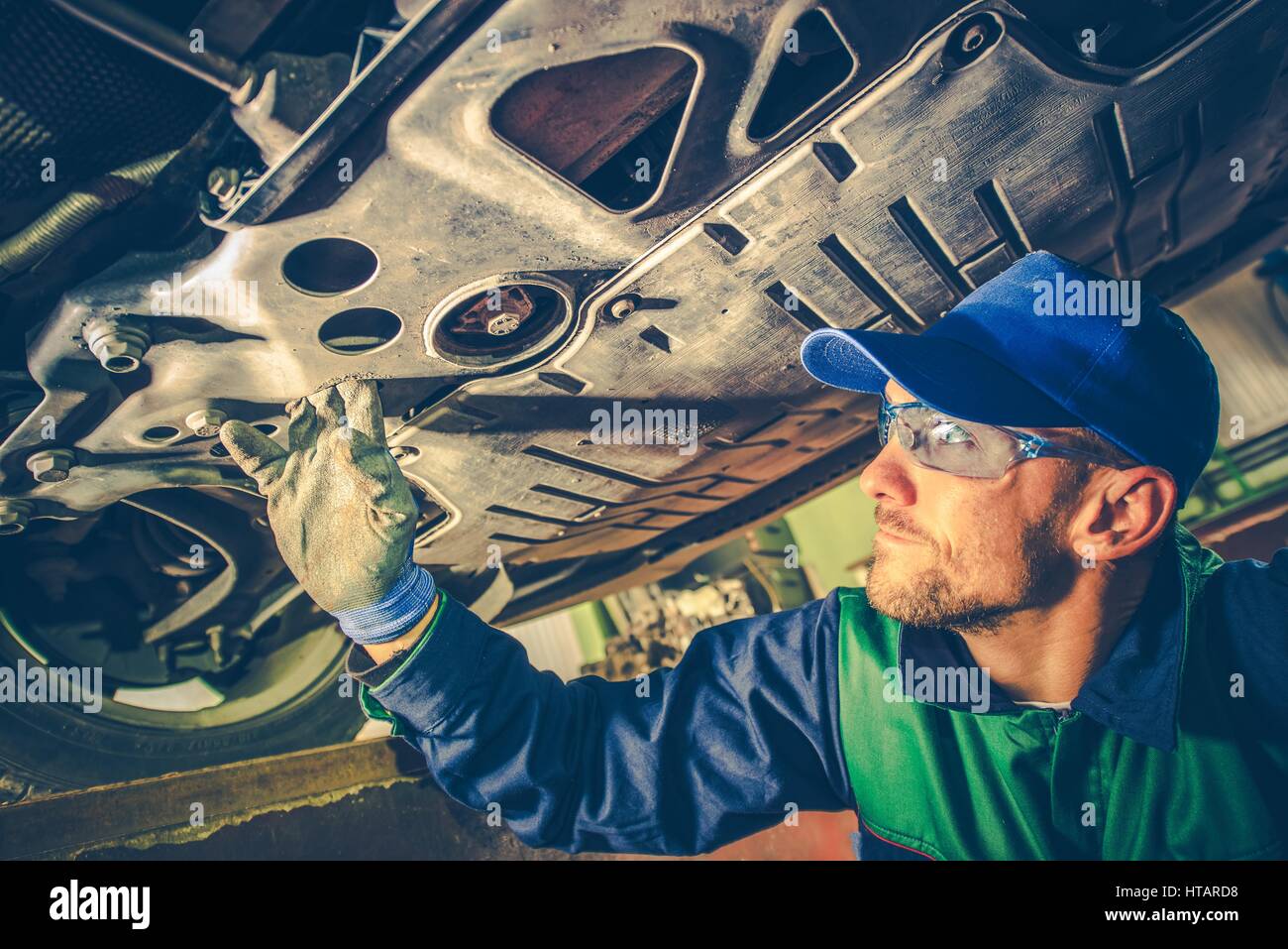 Caucasian Mechanic Fixing the Car. Mechanic Working Under the Vehicle ...