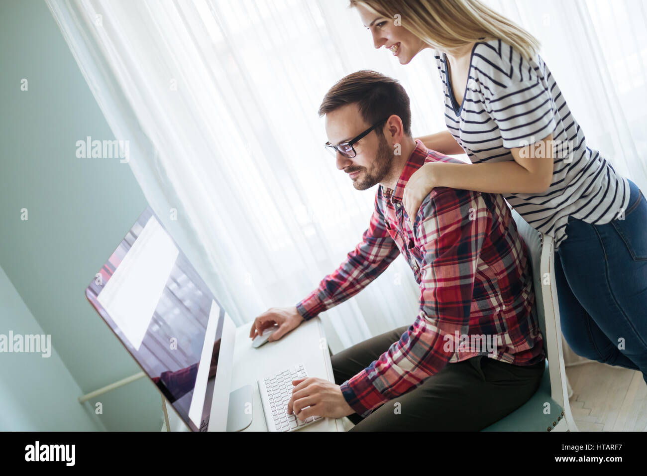 Supportive woman caring for husband working from home Stock Photo - Alamy