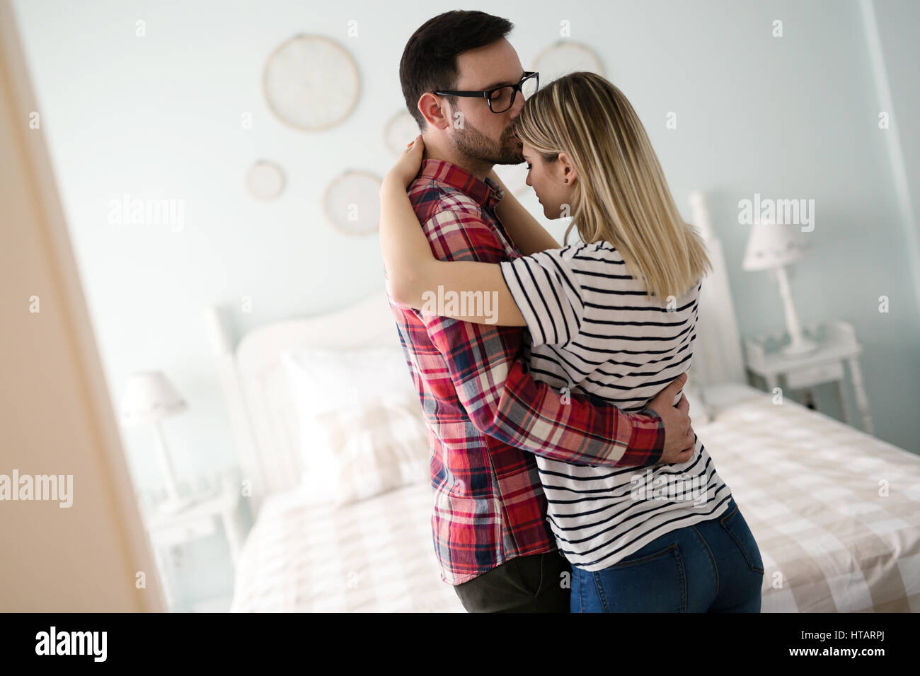 Married couple in love cuddling and hugging at home Stock Photo - Alamy