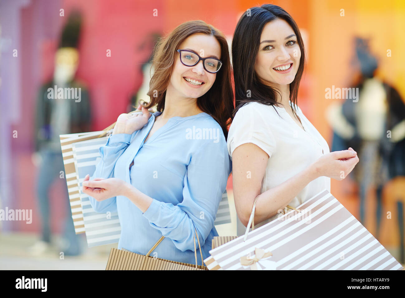 Smiley women enjoying their shopping in the mall Stock Photo - Alamy