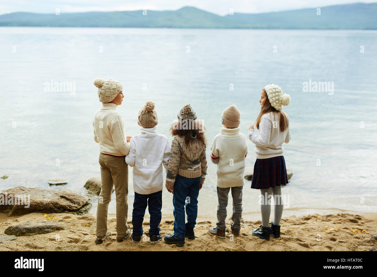 Group of little buddies standing by water Stock Photo - Alamy