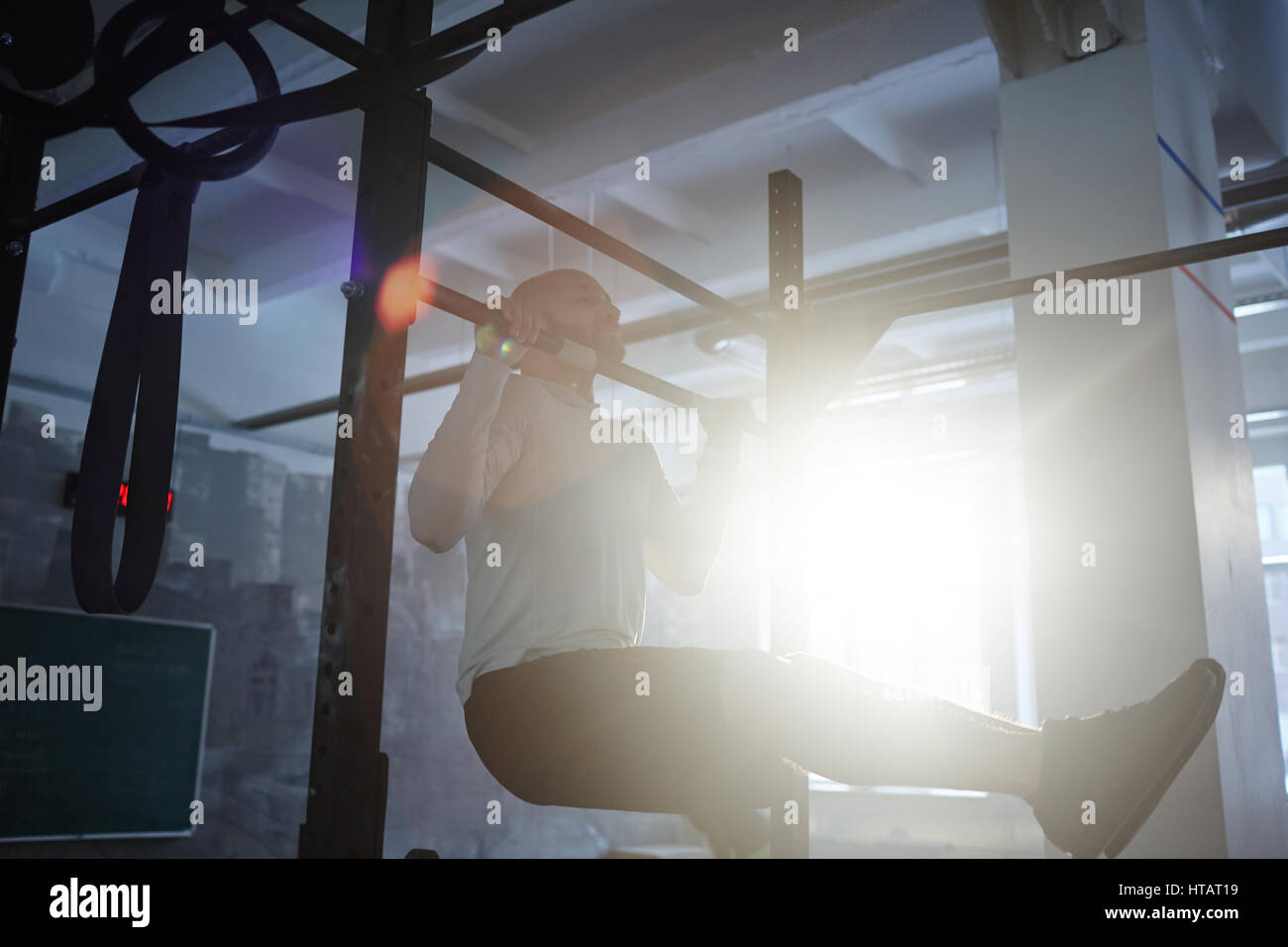 Strong man doing pull-ups in gym Stock Photo - Alamy