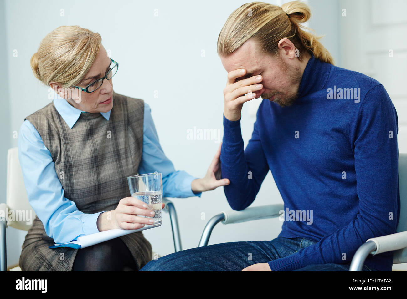 Frustrated young man sharing his problem with counselor Stock Photo - Alamy