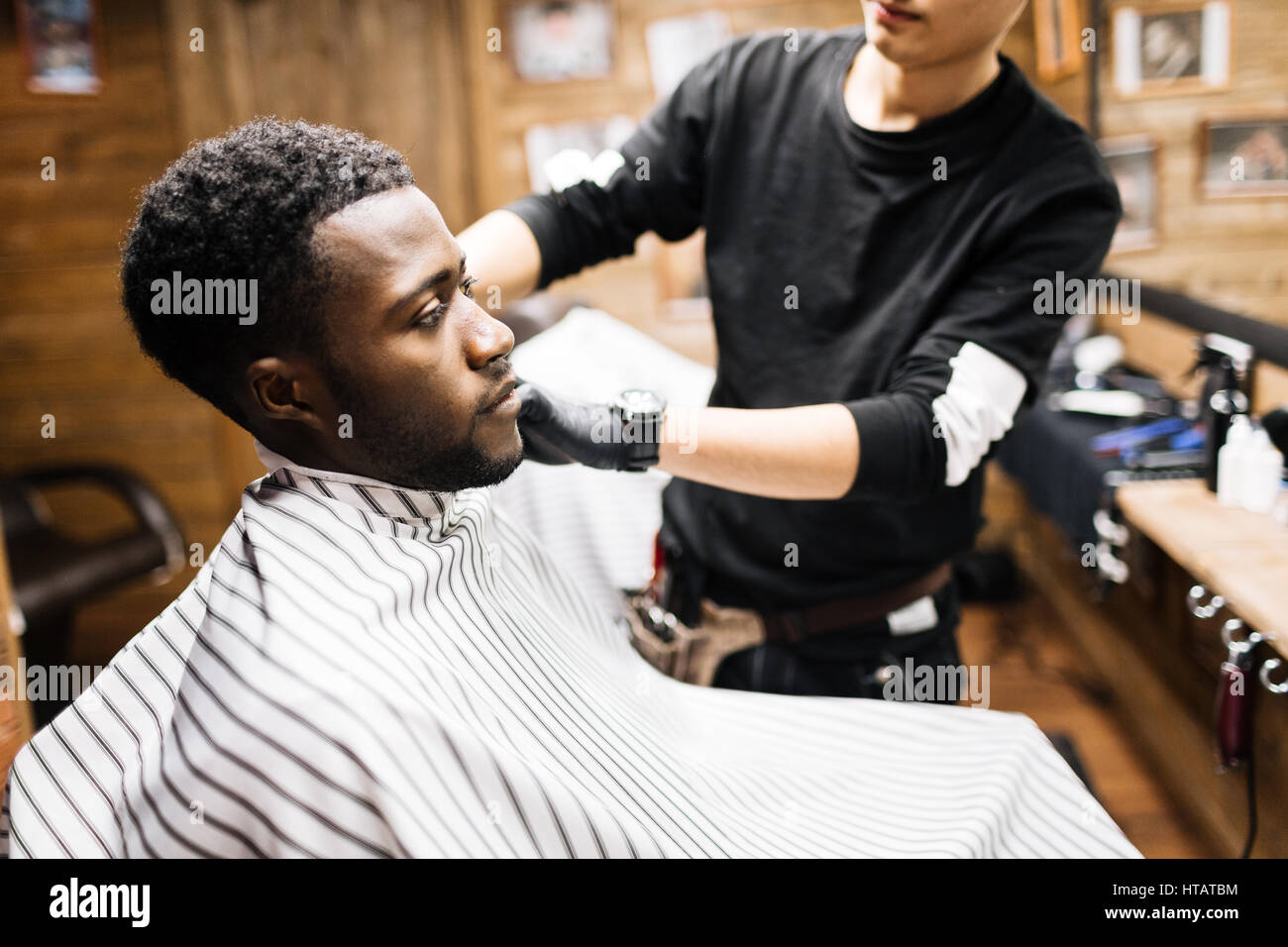 Haidresser preparing young man for haircut Stock Photo - Alamy