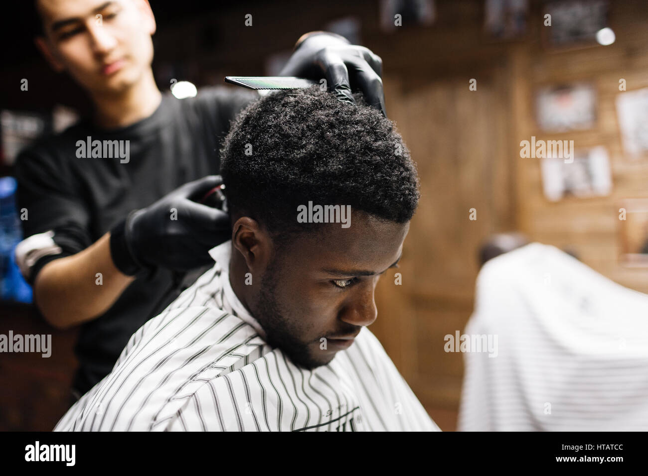Handsome guy having his hair cut in barbershop Stock Photo - Alamy