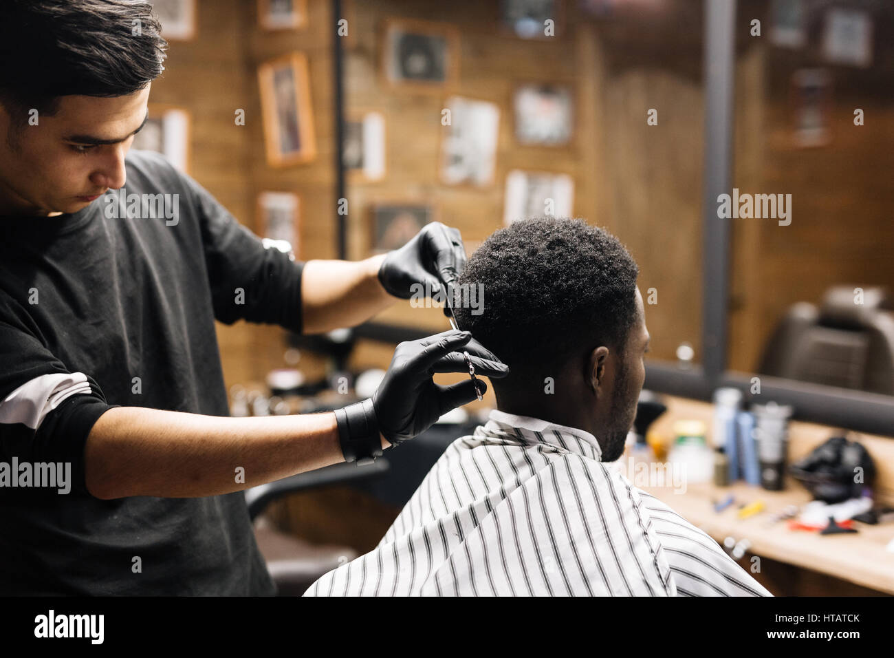 Barbers cutting client hair with scissors Stock Photo - Alamy