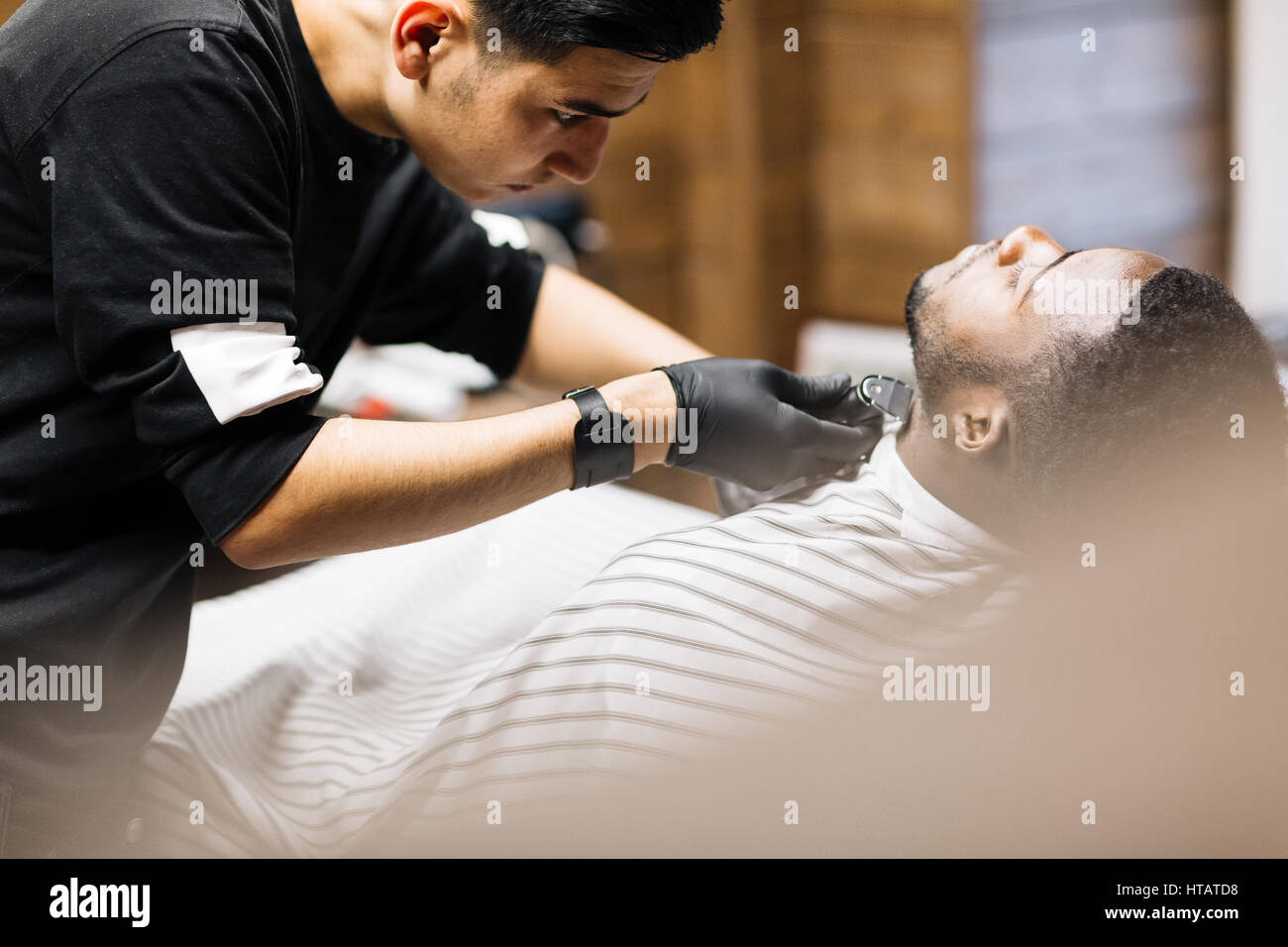 Barber shaving neck of client Stock Photo - Alamy