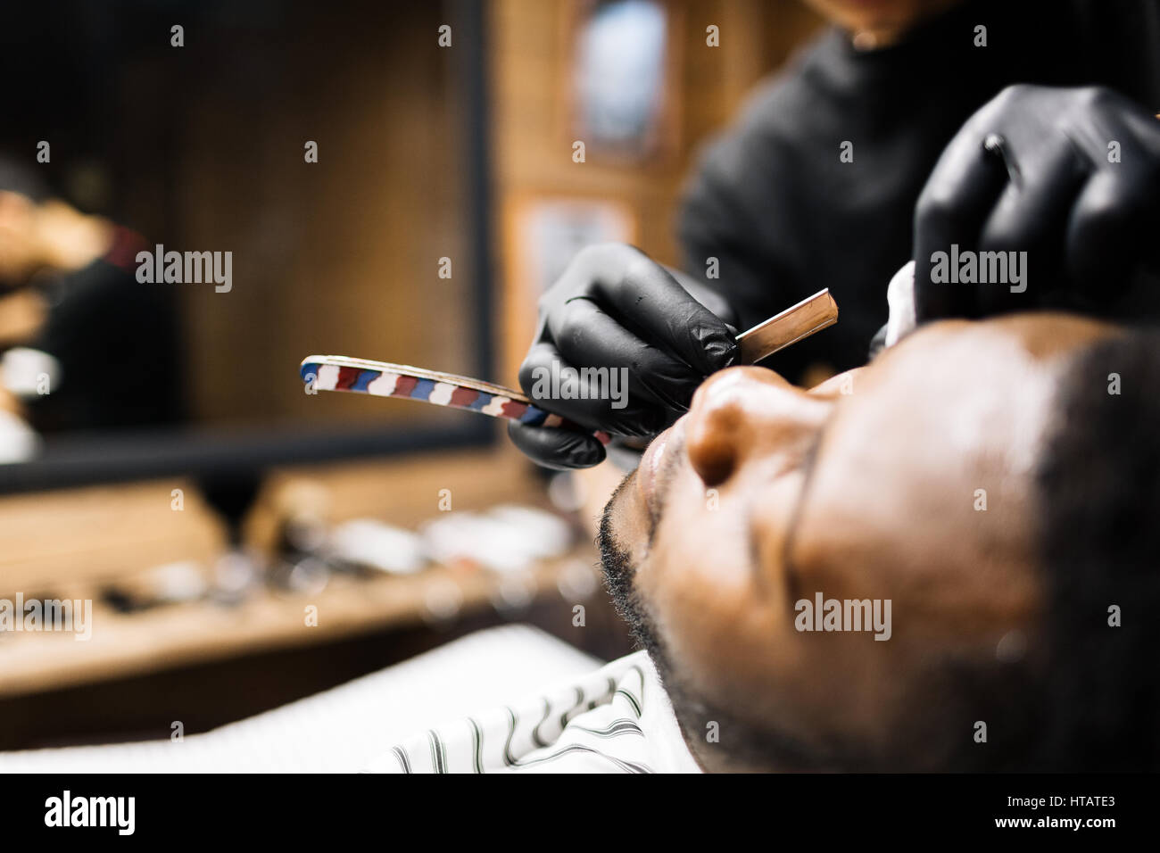 Barber shaving face of his client Stock Photo - Alamy