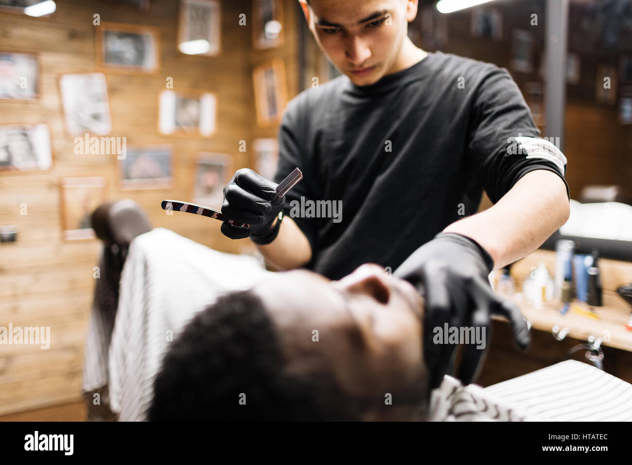 Self-employed barber shaving his client Stock Photo - Alamy