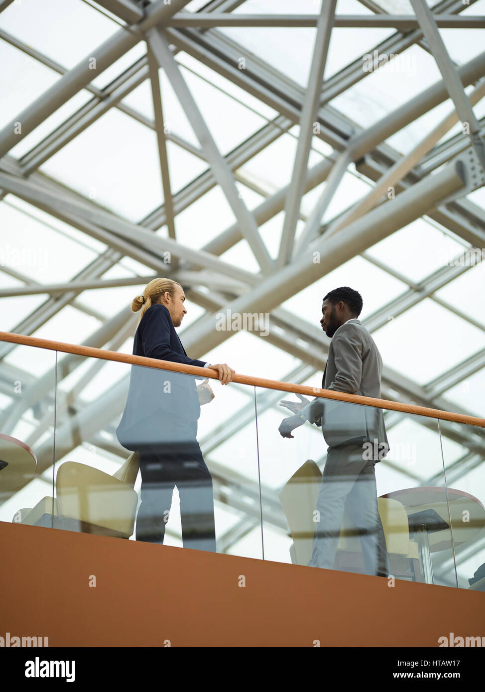Two modern traders talking at meeting in business center Stock Photo ...