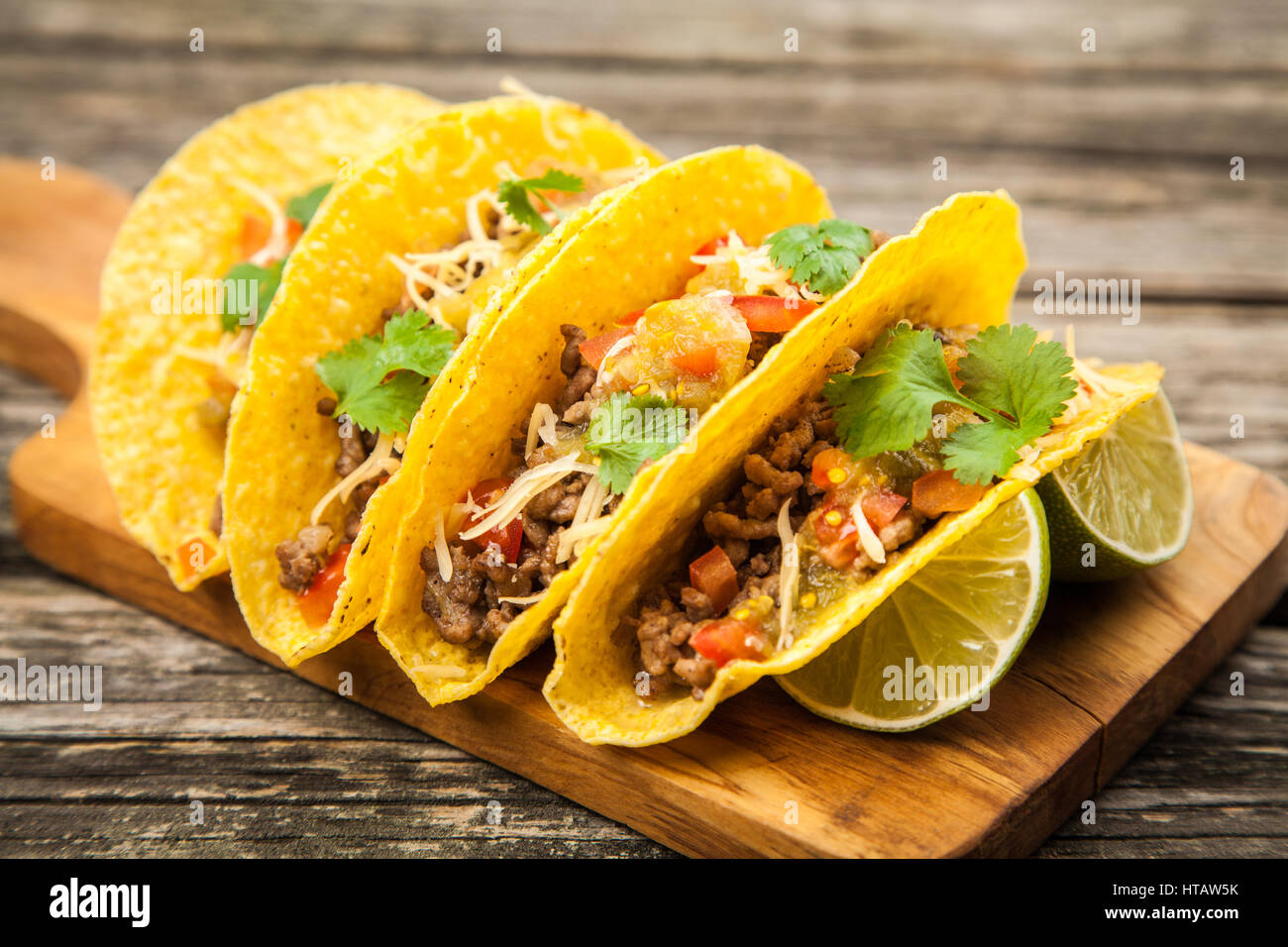 Mexican tacos with beef, cheese, tomato and green salsa Stock Photo - Alamy