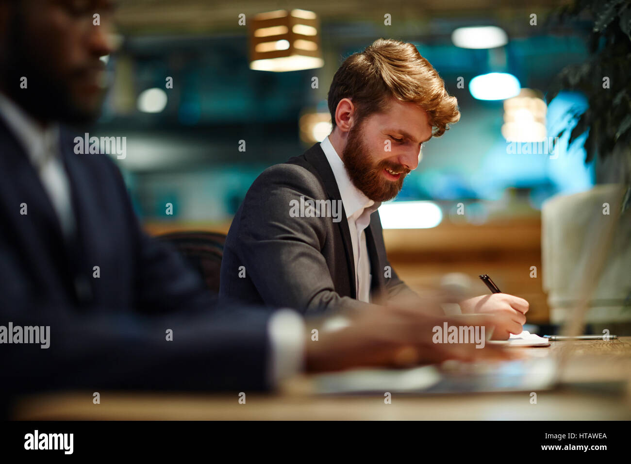 Young man writing his working plan or just making notes Stock Photo - Alamy