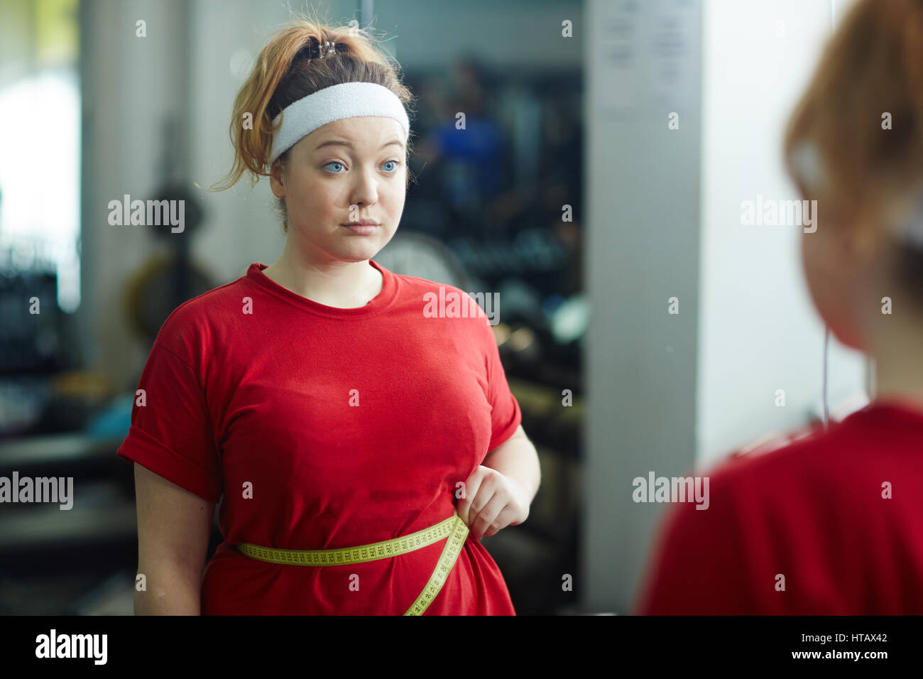 Overweight woman looking in mirror hi-res stock photography and images ...