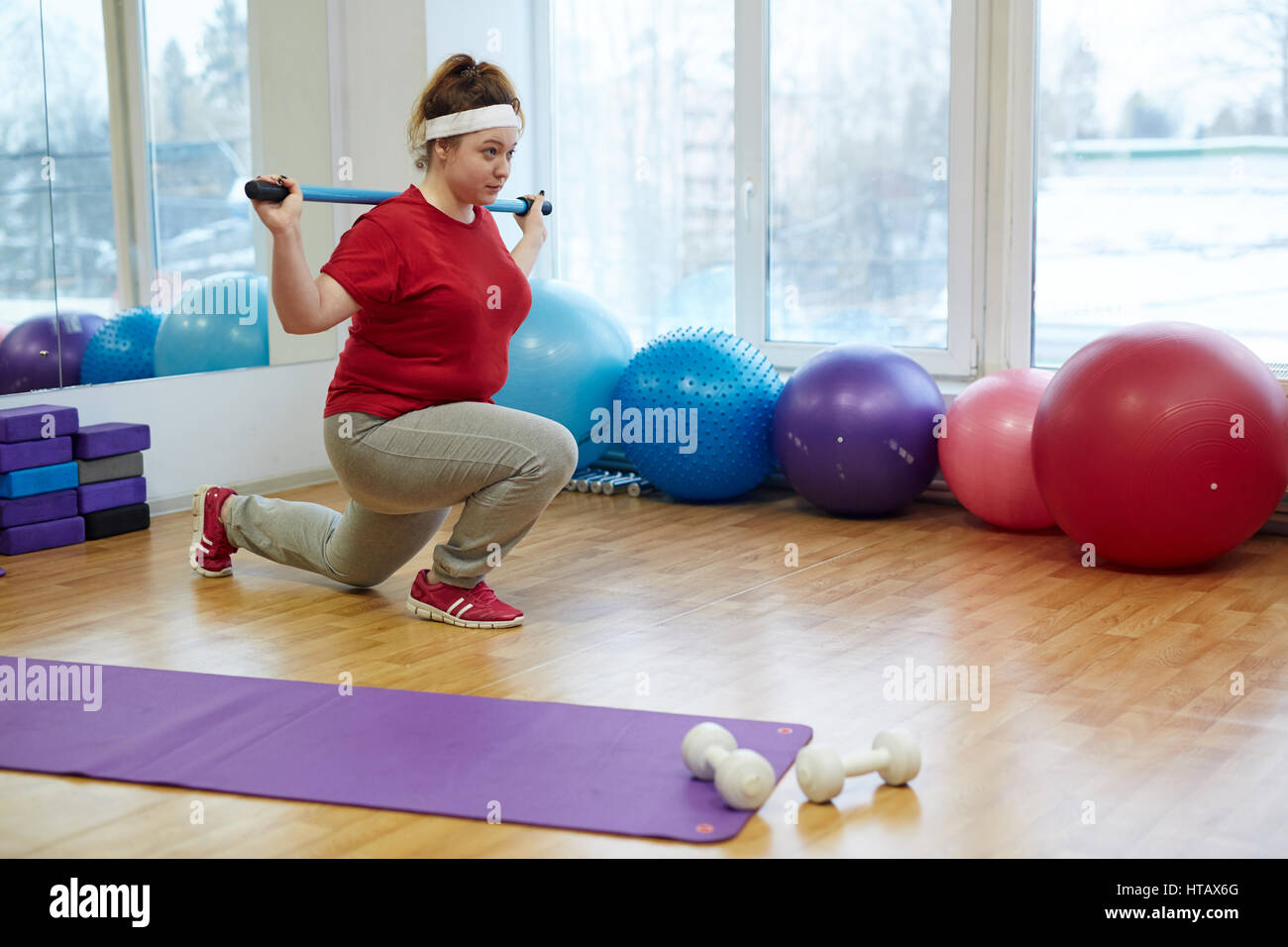 Side view portrait of determined overweight woman working out in ...