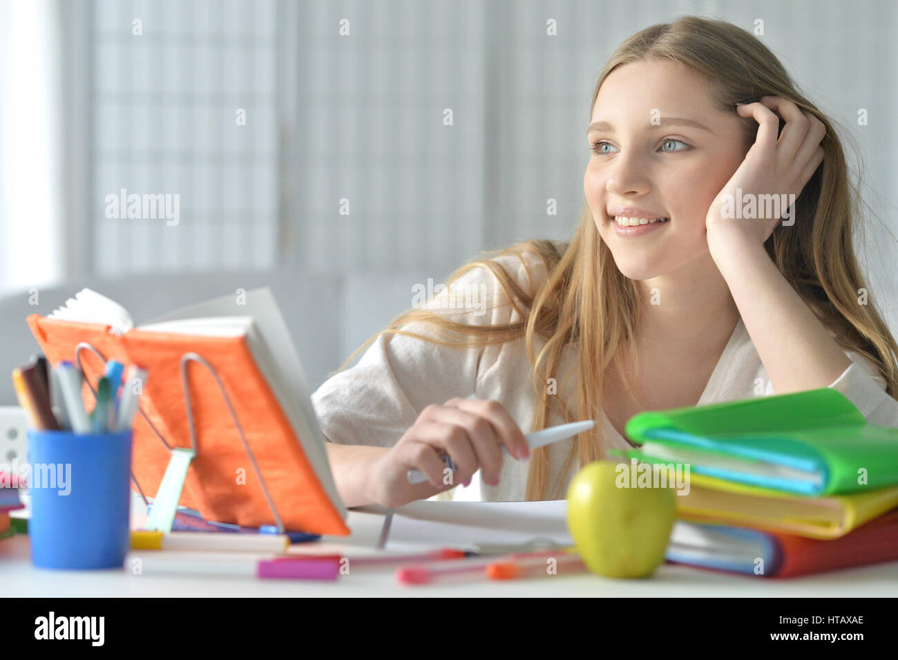 Portrait of a cute girl does lessons Stock Photo - Alamy