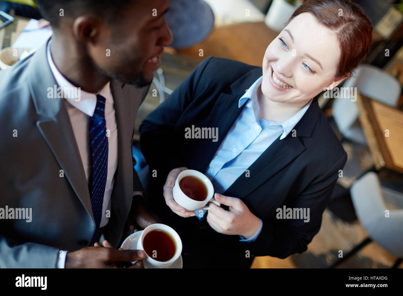 High angle of two business people interacting during coffee break ...