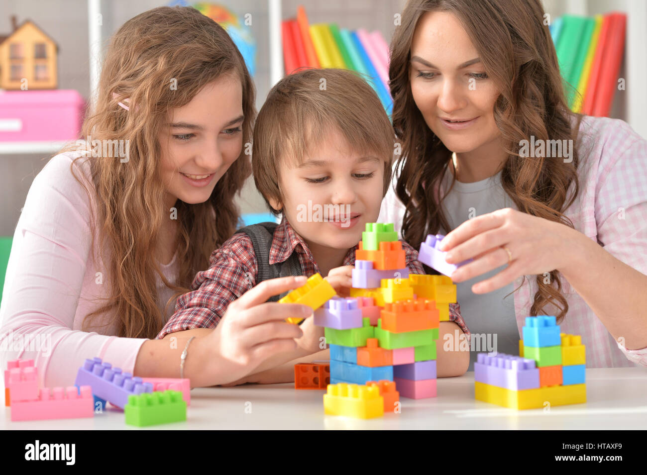Happy family of three playing lego game at home Stock Photo - Alamy
