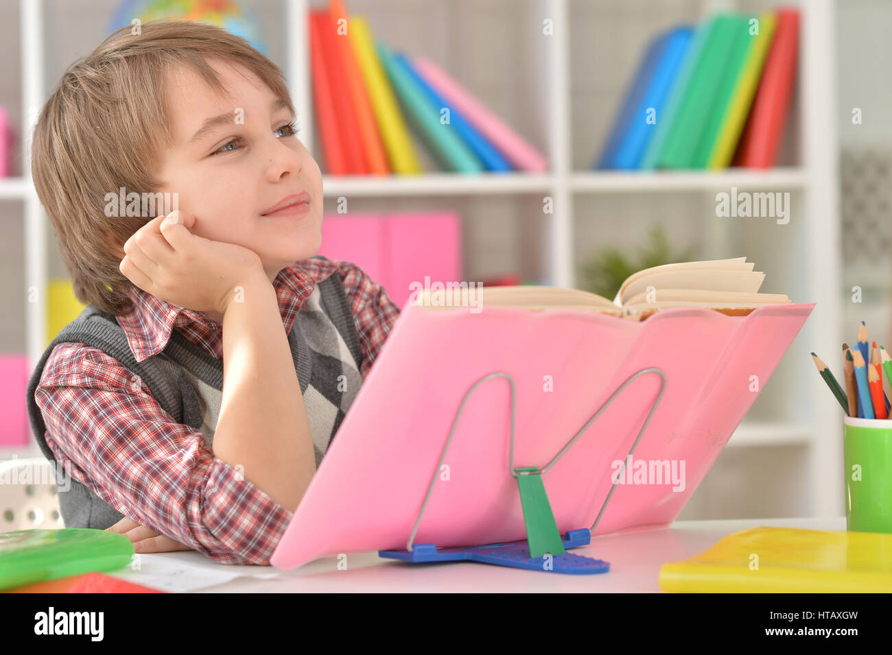 Portrait of a concentrated little boy doing his homework Stock Photo ...