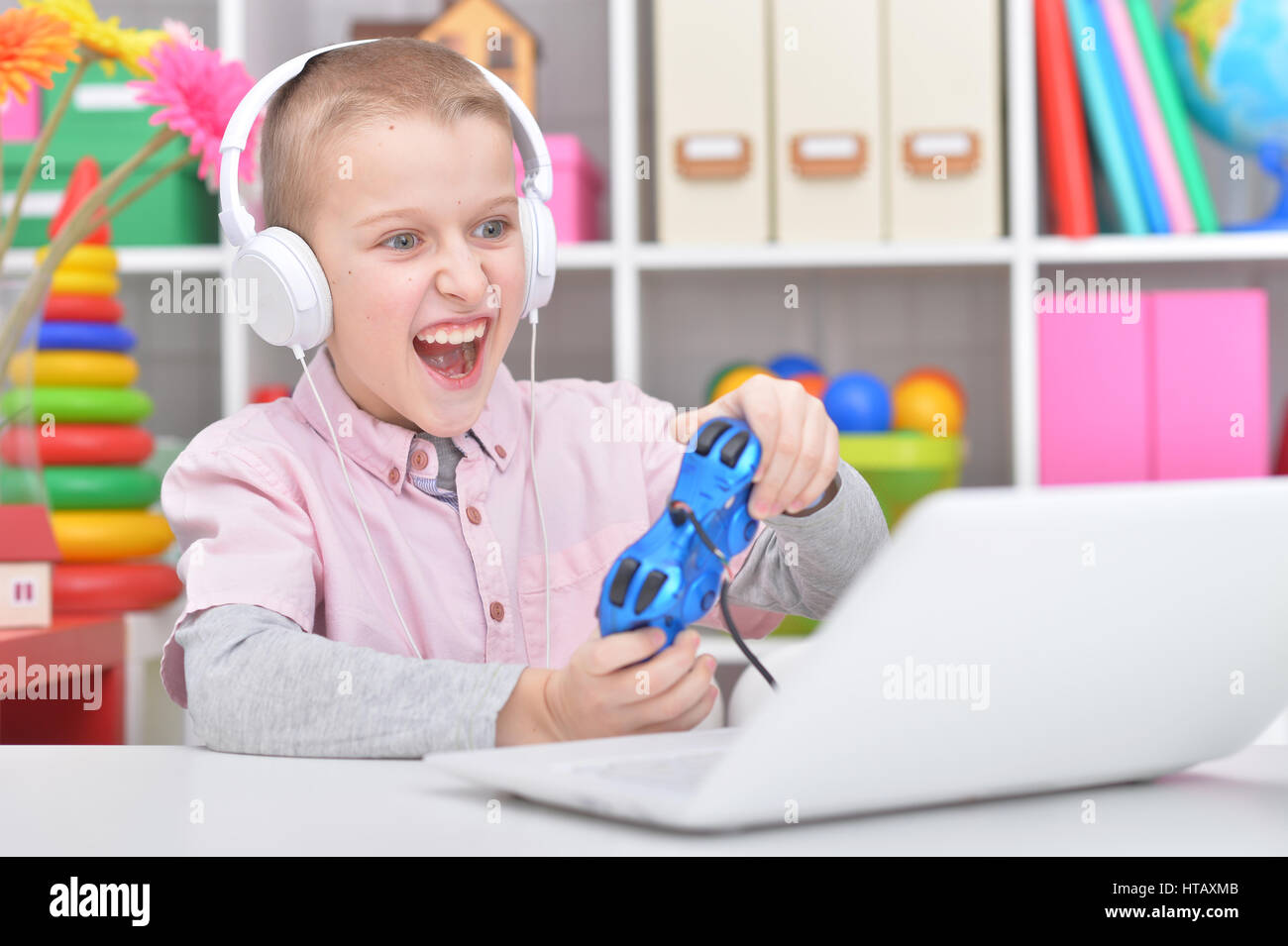 Portrait of a boy playing a computer game Stock Photo - Alamy