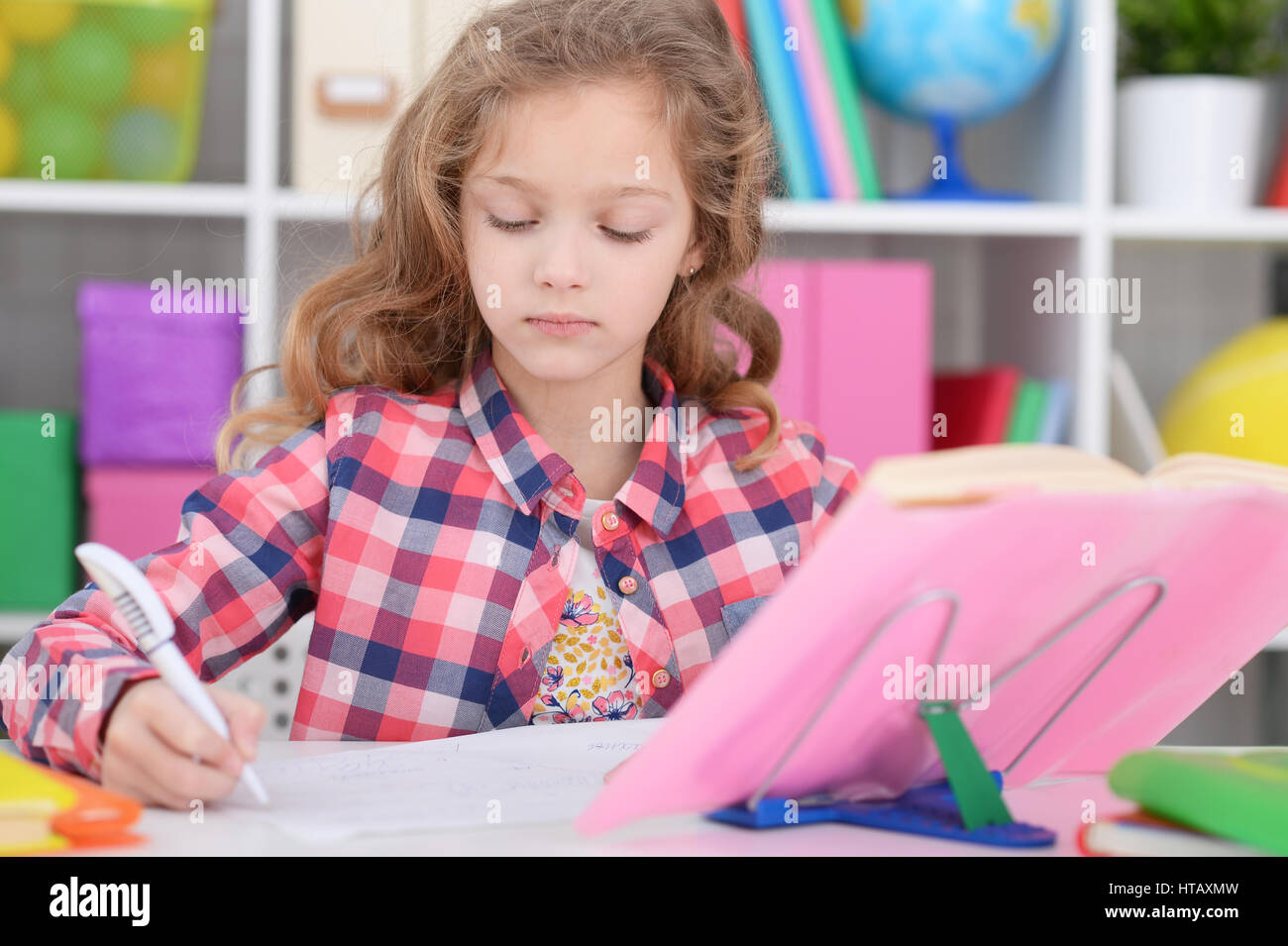 Portrait of a cute girl does lessons Stock Photo - Alamy