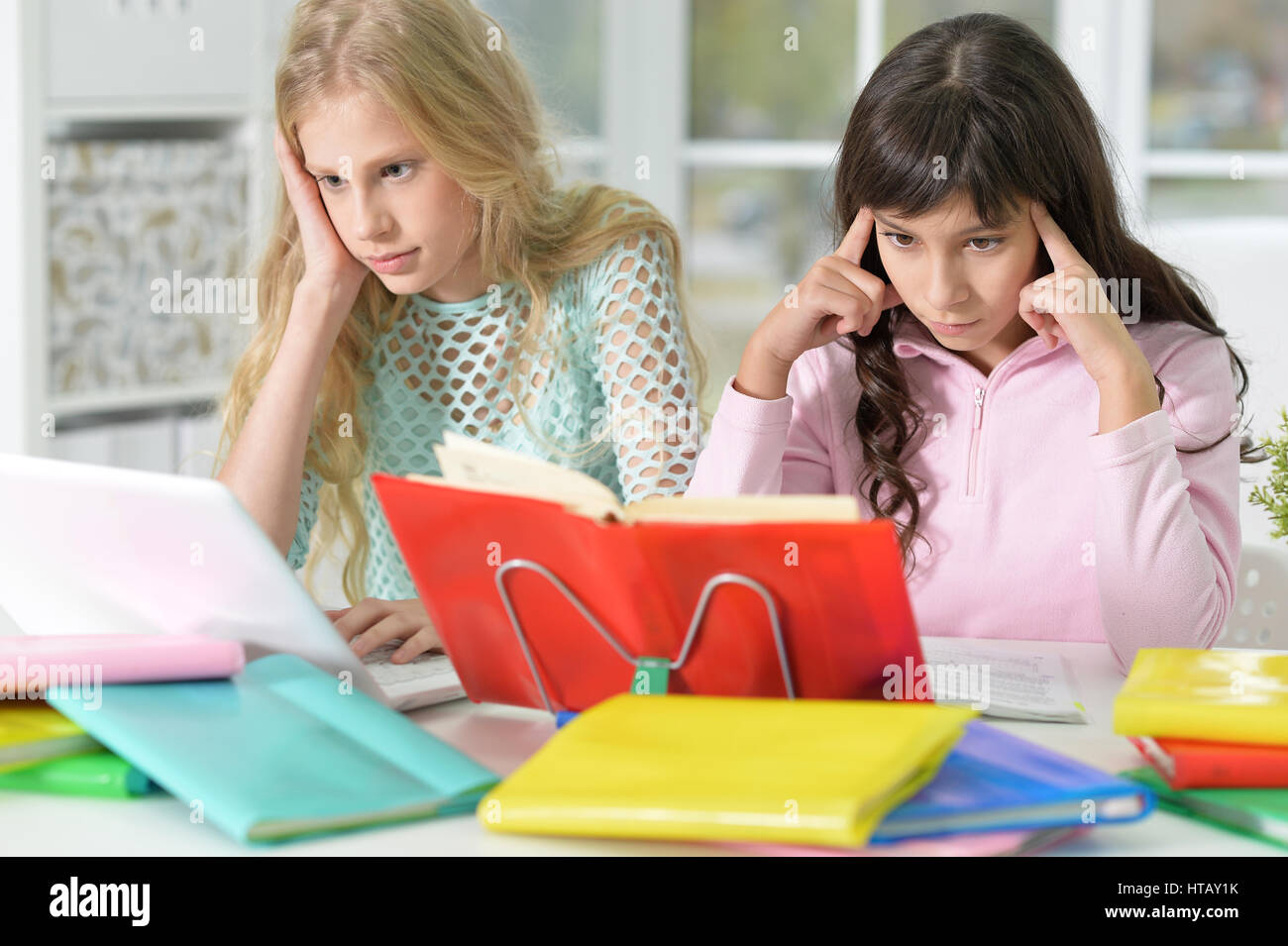 Portrait of two girls with their homework Stock Photo - Alamy