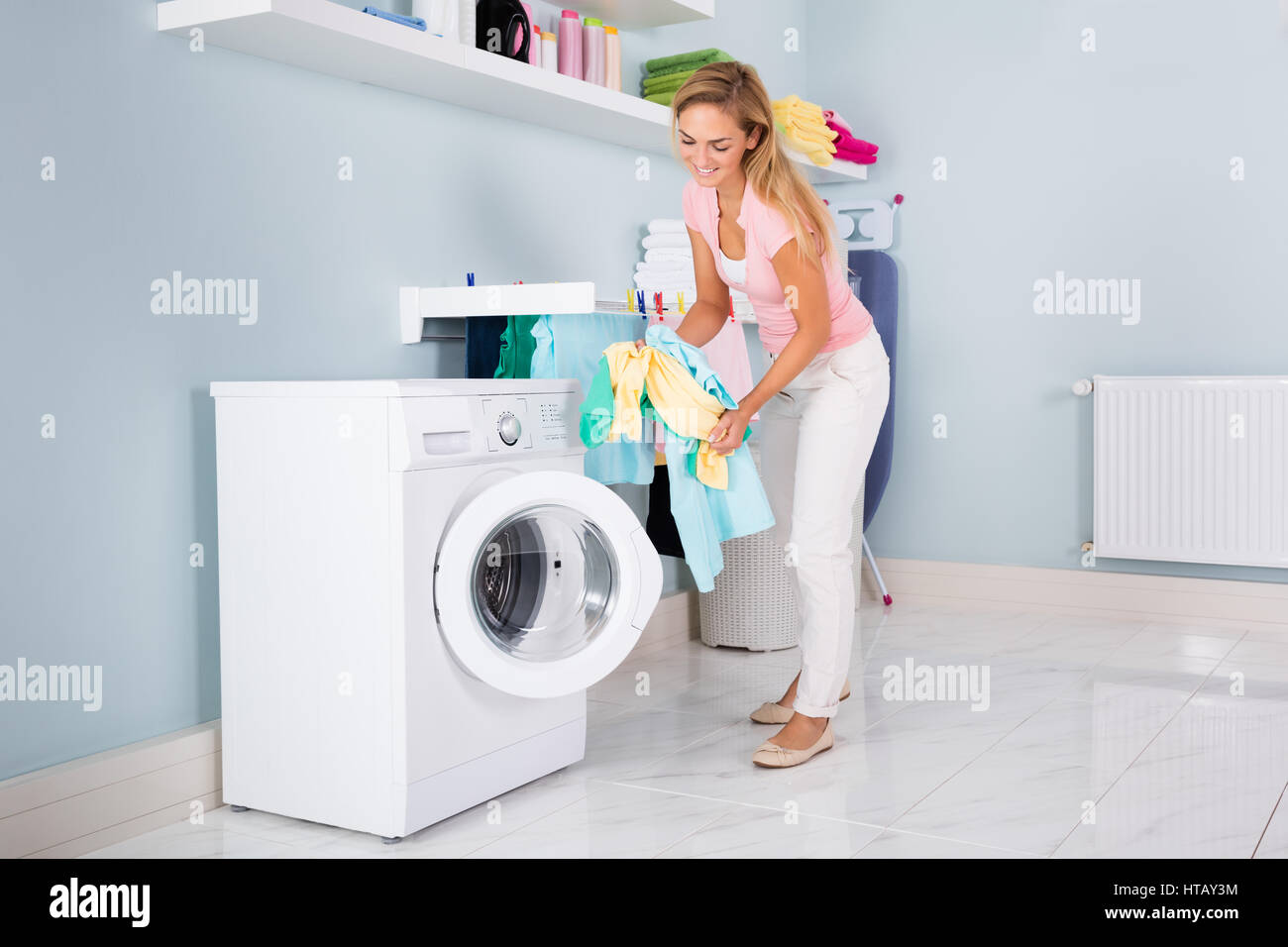 Woman laundry bending hi-res stock photography and images - Alamy