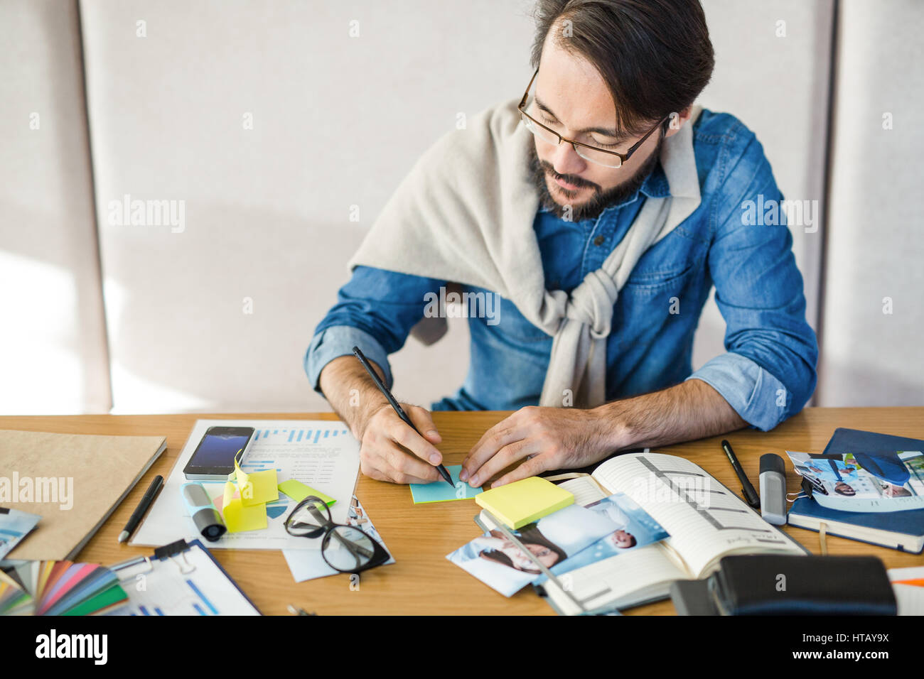 Professional designer writing plan of work Stock Photo - Alamy