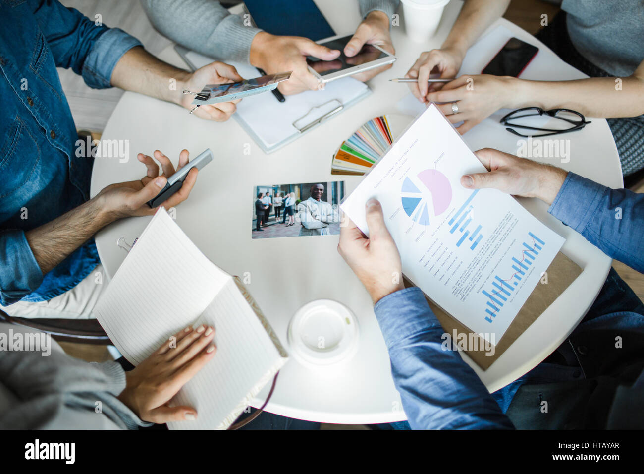 Human hands with paper, gadget and notebook during discussion Stock ...