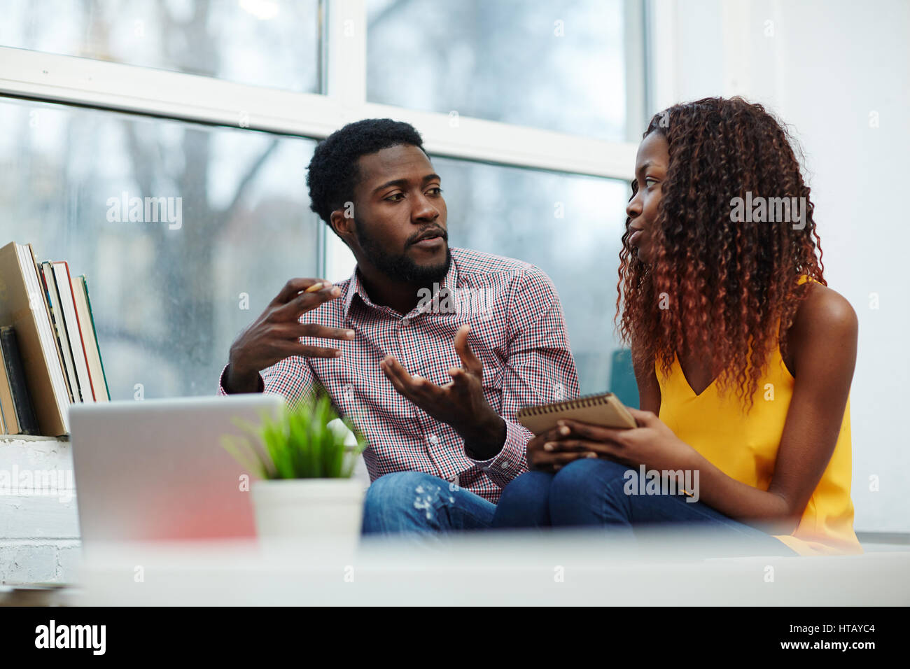 Businessman explaining his creative ideas to young woman Stock Photo ...