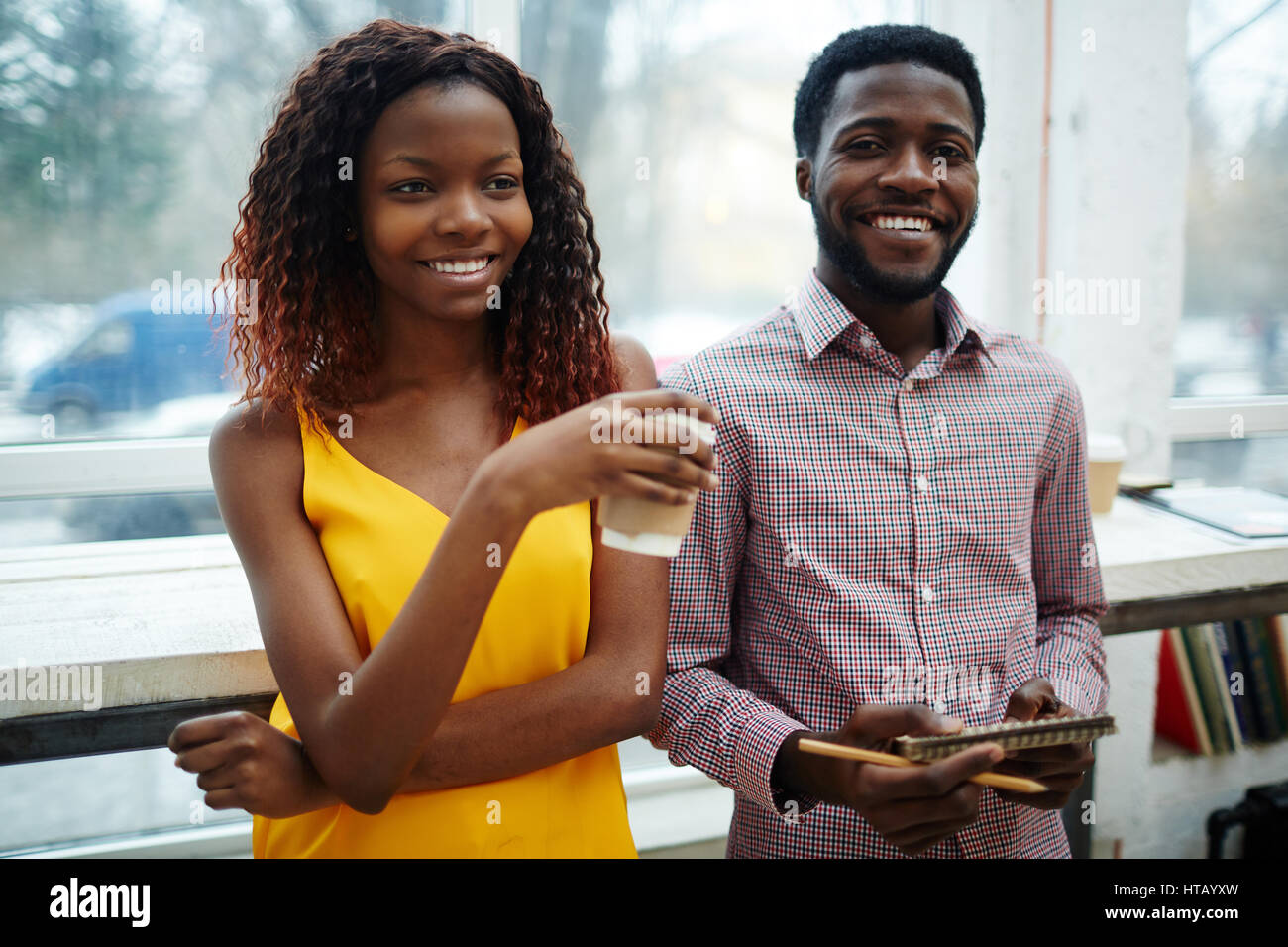 Happy young staff having coffee break in cafe Stock Photo - Alamy