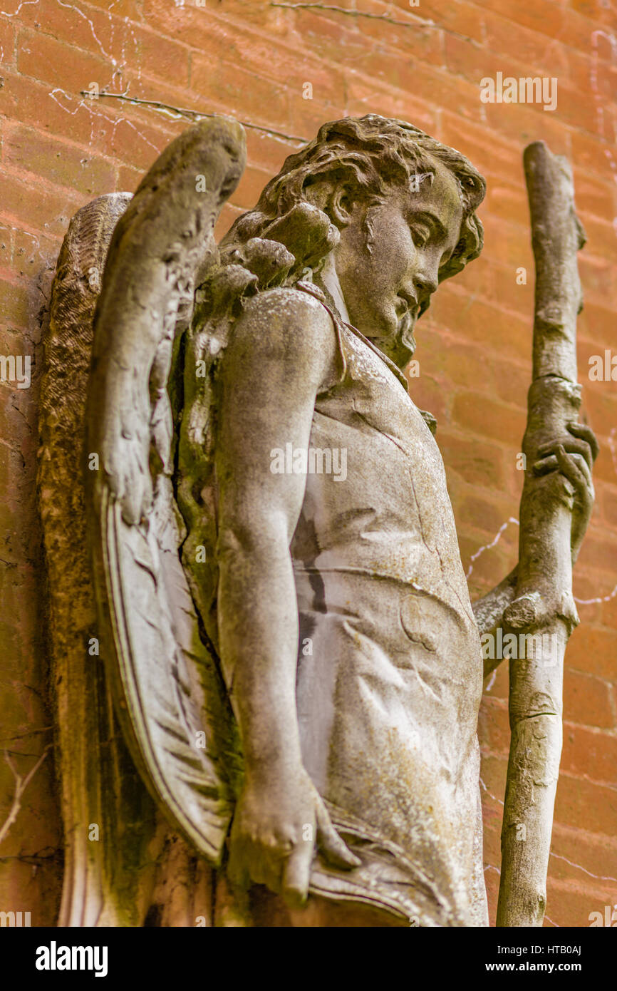statue of angel holding stick Stock Photo - Alamy