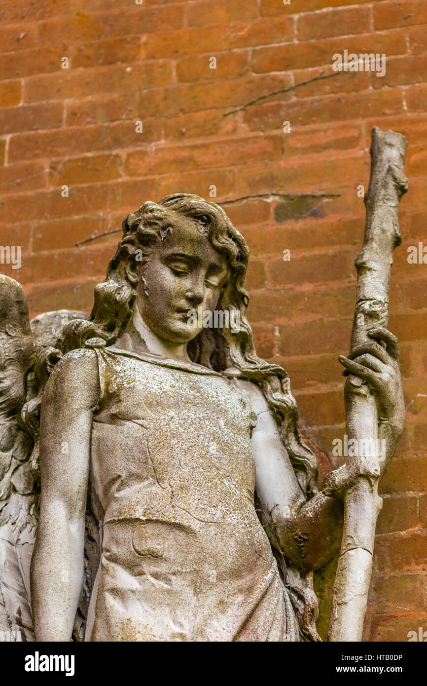 statue of angel holding stick Stock Photo - Alamy